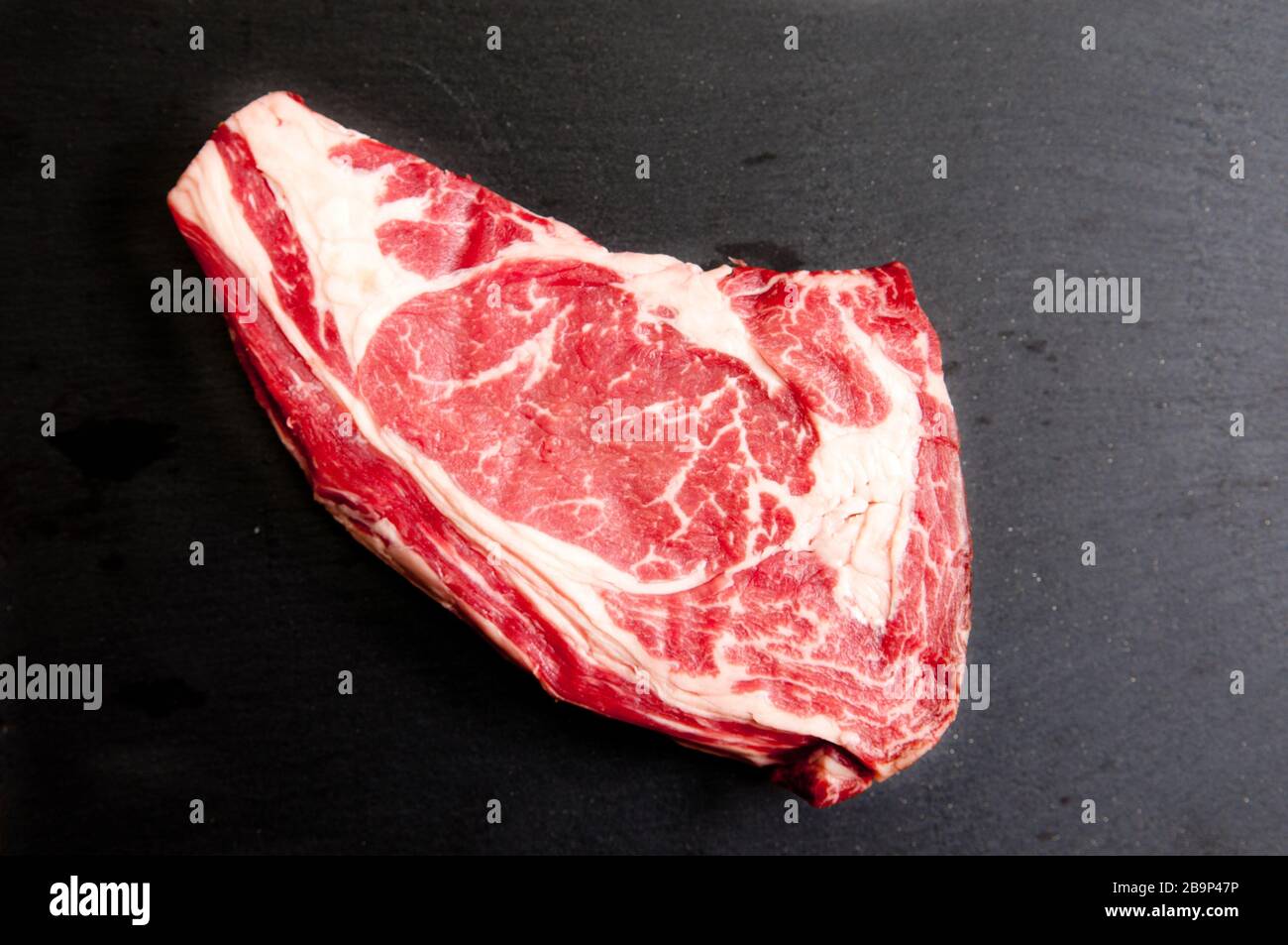 A raw ribeye steak Stock Photo - Alamy