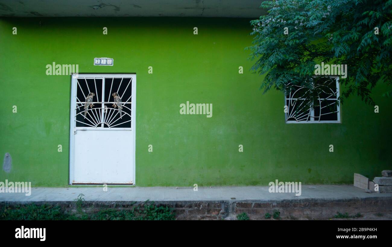 Bright Lime Green Building with Large White Door In Small Mexican ...