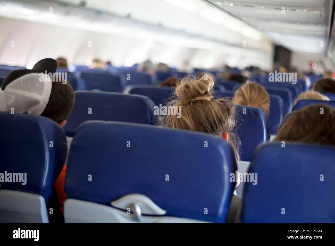 Passengers stay in their seats during a flight Stock Photo - Alamy