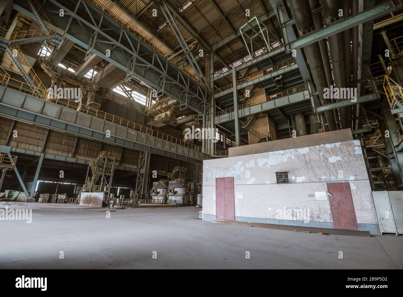 Interior of an old abandoned industrial steel factory Stock Photo - Alamy