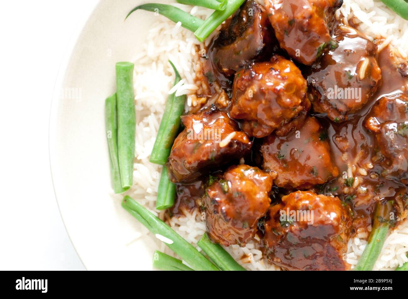A honey garlic meatballs with white rice Stock Photo - Alamy
