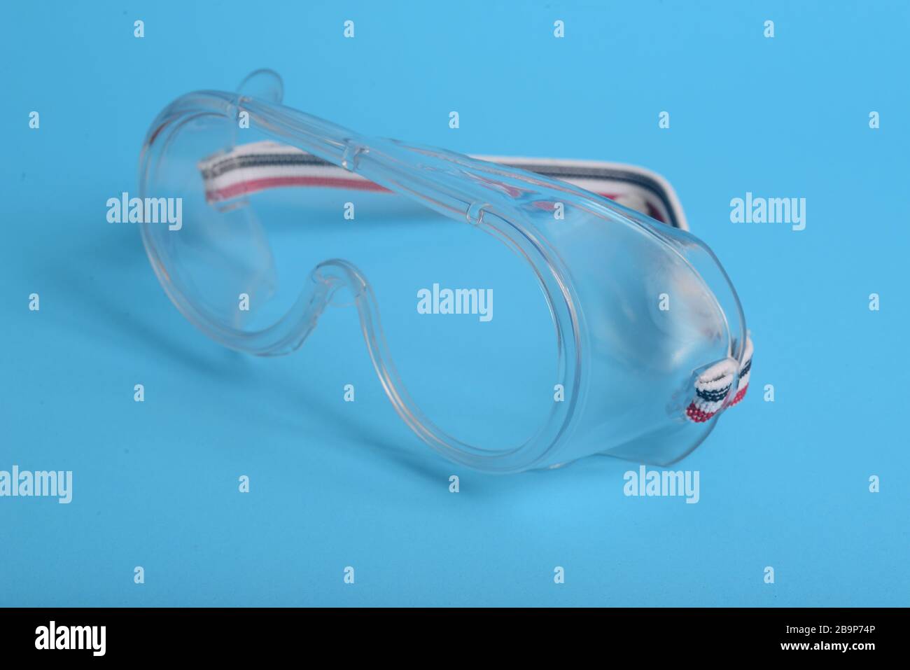 transparent plastic laboratory glasses on blue background Stock Photo ...