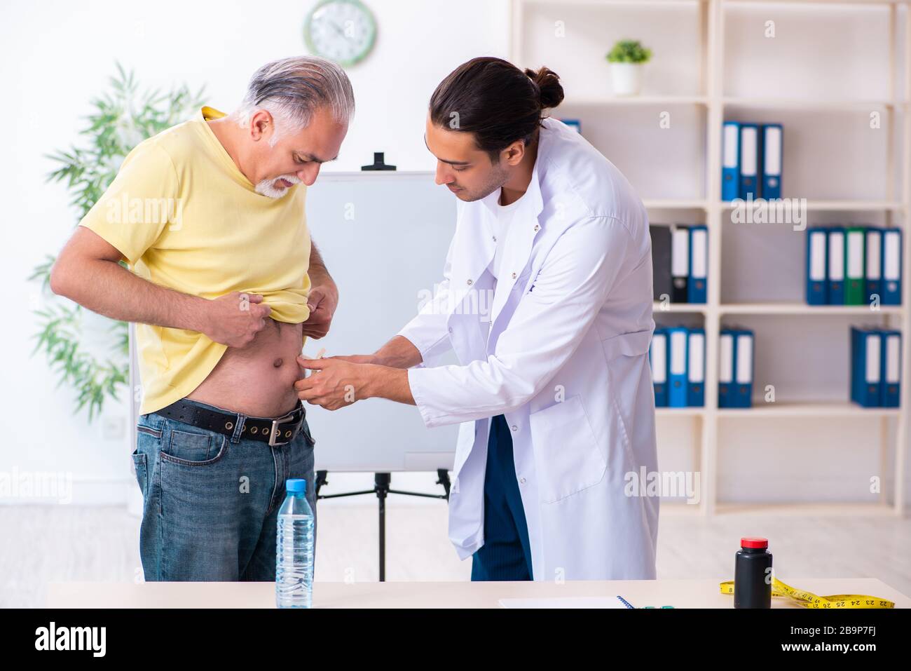 The doctor dietician giving advices to fat overweight patient Stock ...