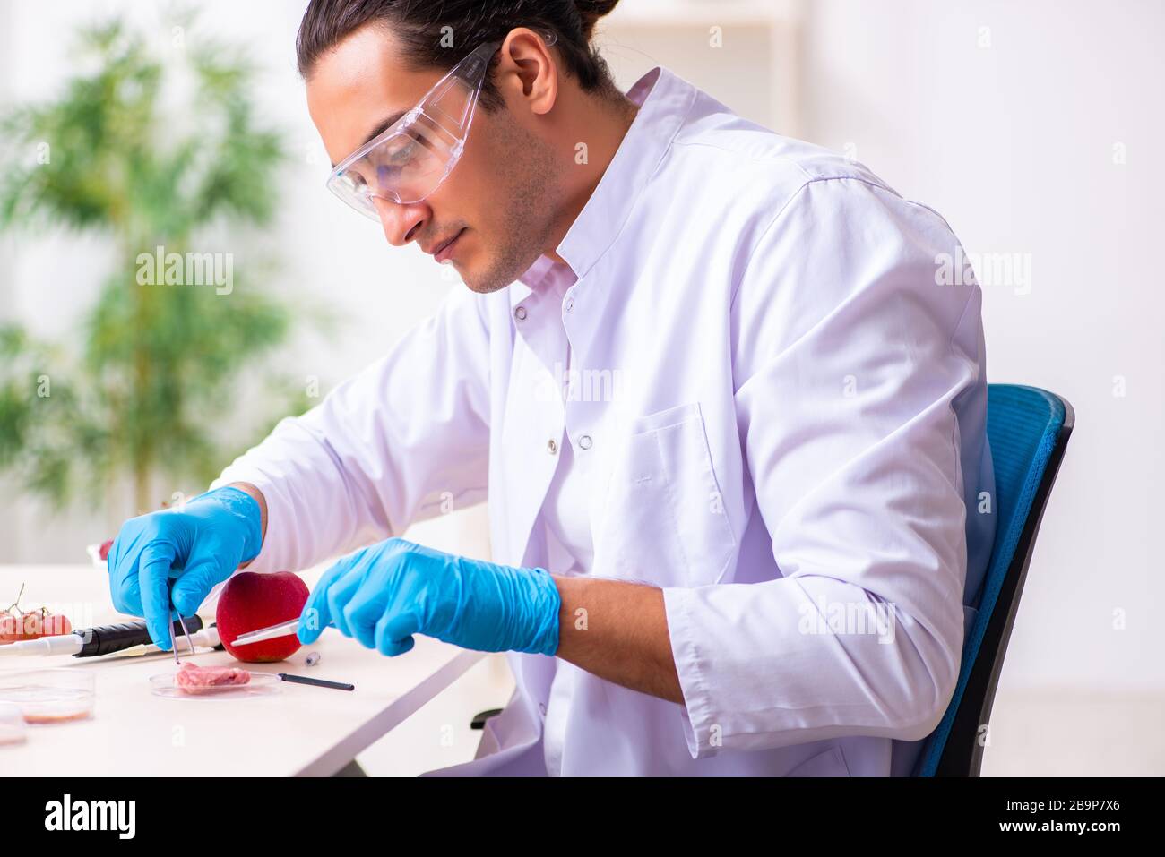 Young nutrition expert testing food products in lab Stock Photo - Alamy