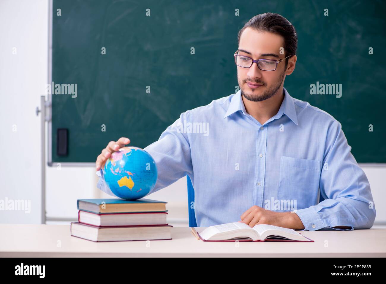 Young geography teacher explaining lesson hi-res stock photography and ...