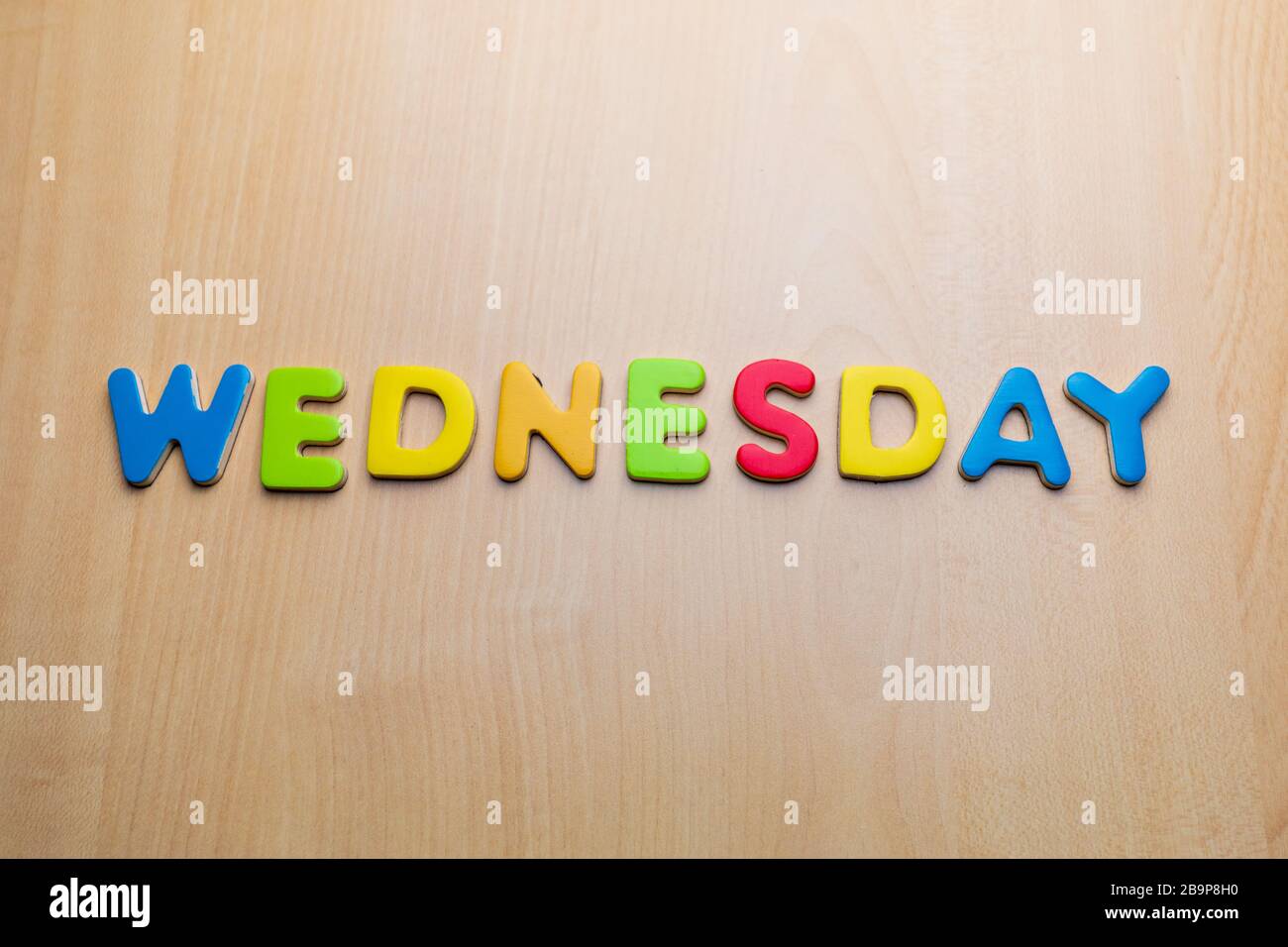 Wednesday word written with colorful letters on wooden table background ...