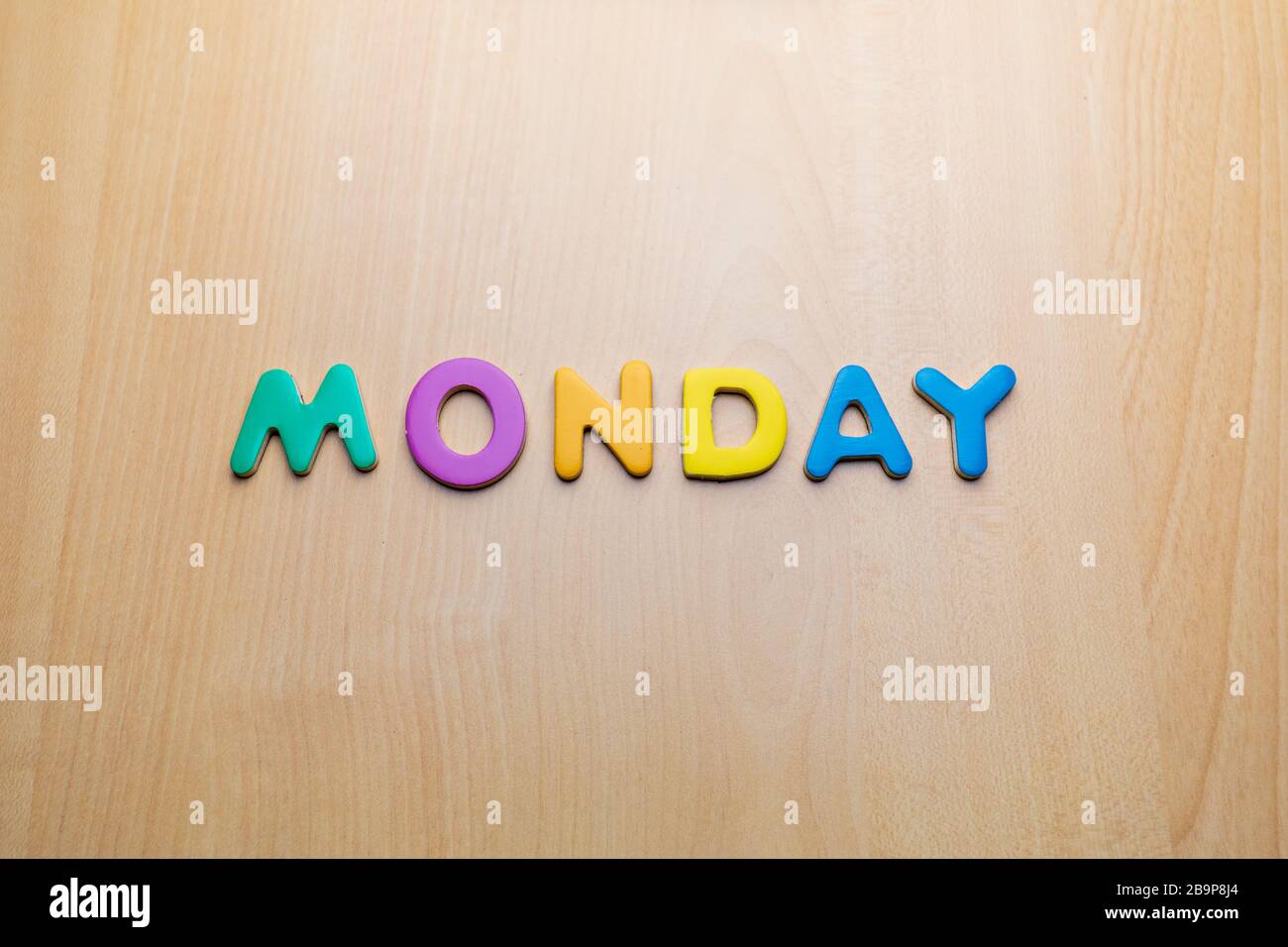 Monday word written with colorful letters on wooden table background ...