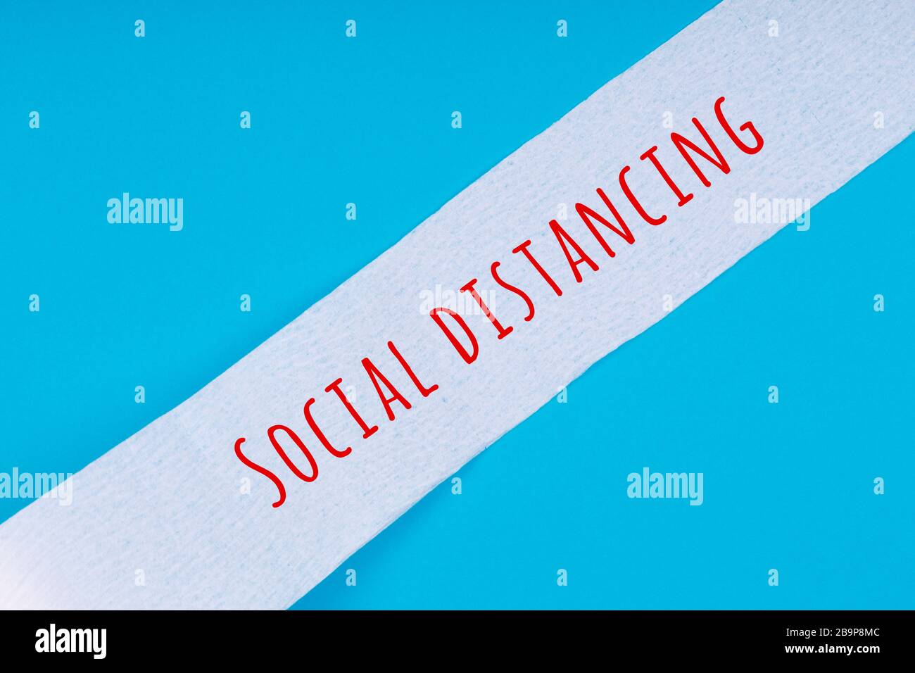 Toilet paper roll with Social distancing wording on the bright blue ...