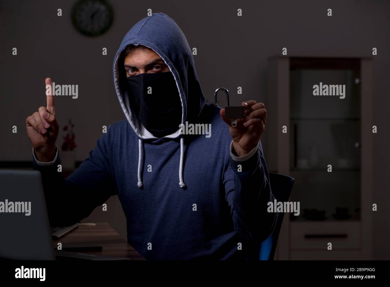 Male hacker hacking security firewall late in the office Stock Photo ...