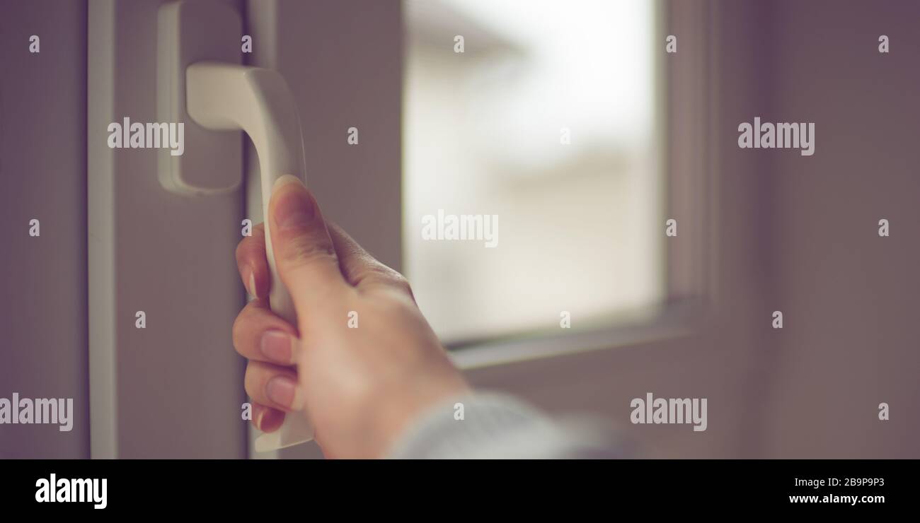 Woman's hand opens the window, side view closeup Stock Photo - Alamy