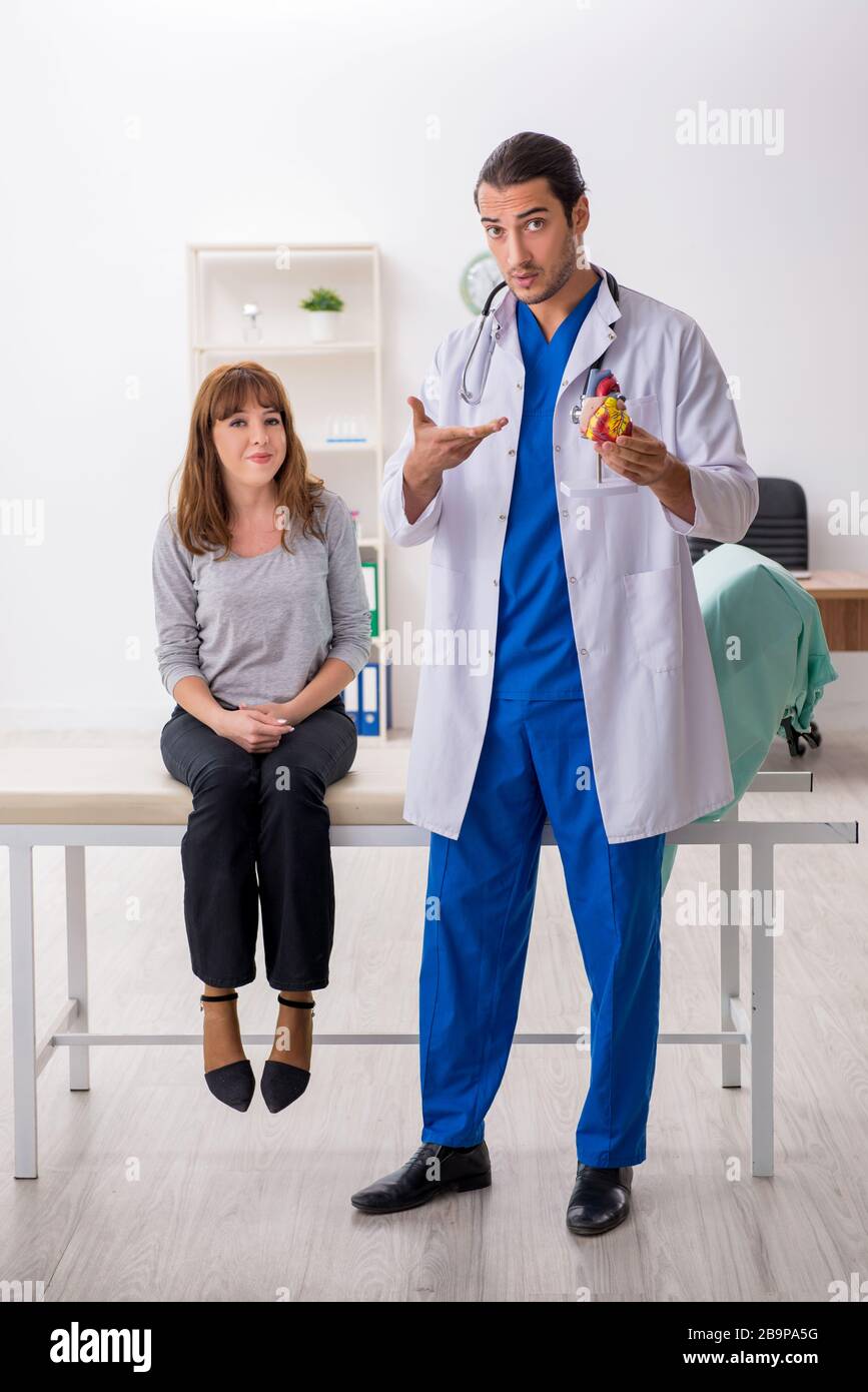 Young woman visiting doctor cardiologist Stock Photo - Alamy