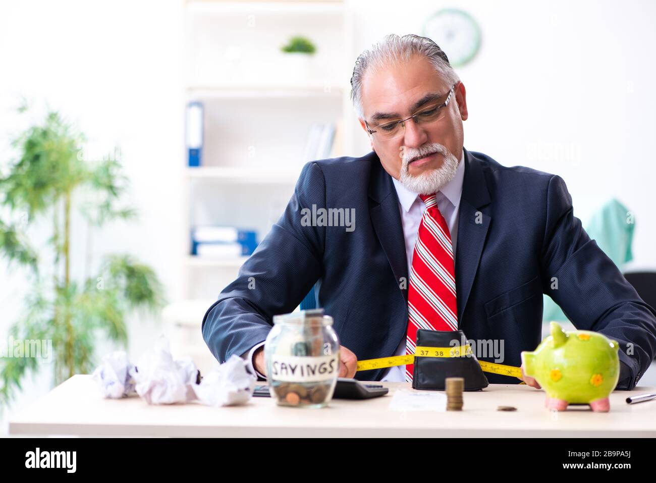 Old accountant in budget planning concept Stock Photo - Alamy