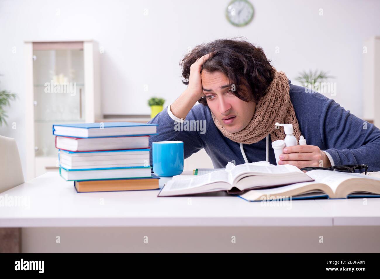 The sick male student suffering at home Stock Photo - Alamy