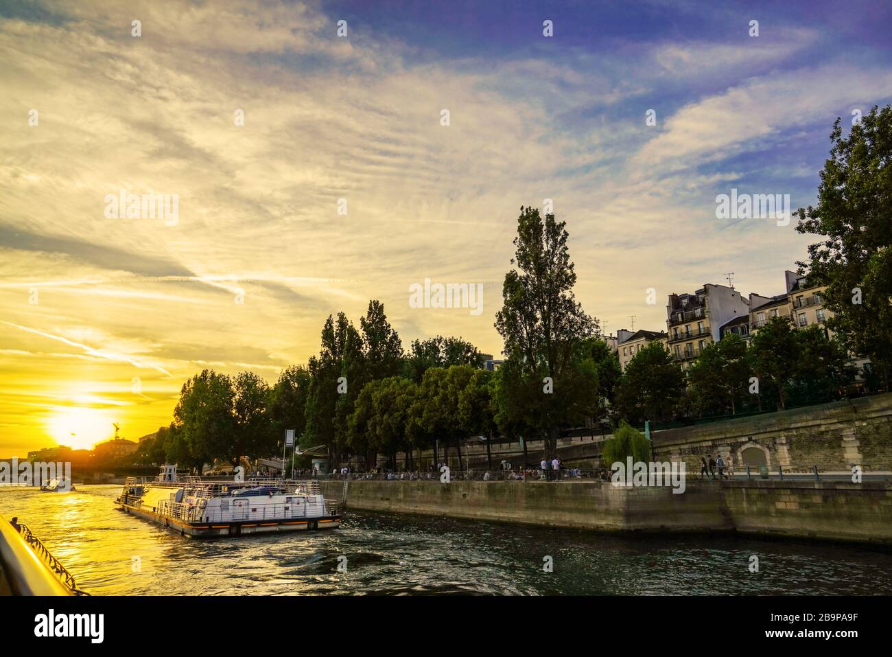 The cruise ship and beautiful sunset view of the Seine River in Paris ...