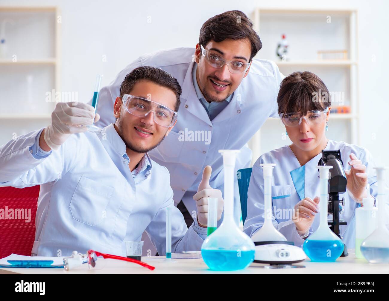 The team of chemists working in the lab Stock Photo - Alamy
