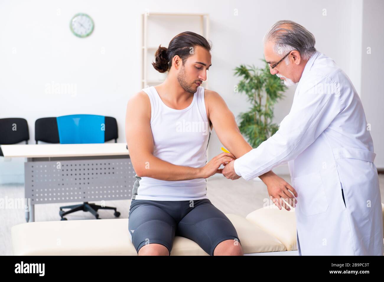 The young male patient visiting experienced doctor Stock Photo - Alamy