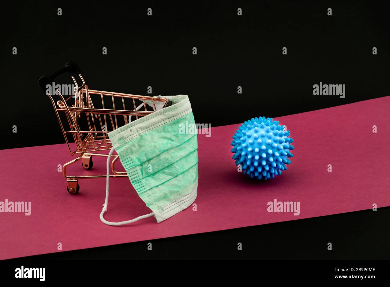 Virus molecule against shopping cart and medical face mask conceptual ...
