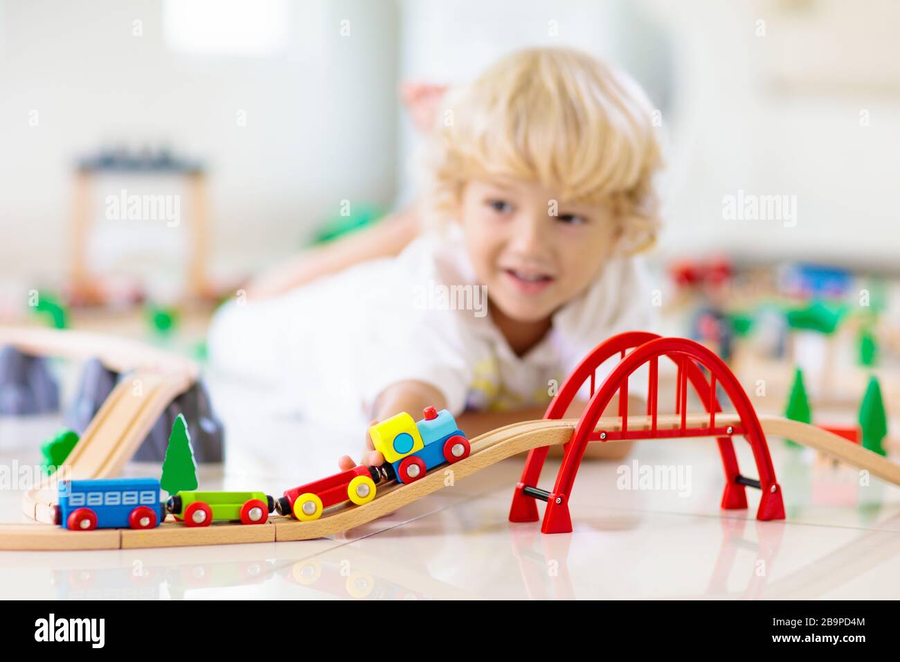 Kids play with wooden railway. Child with toy train. Educational toys ...