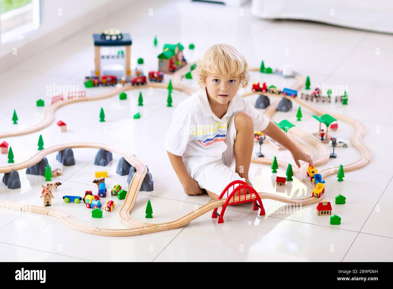 Kids play with wooden railway. Child with toy train. Educational toys ...