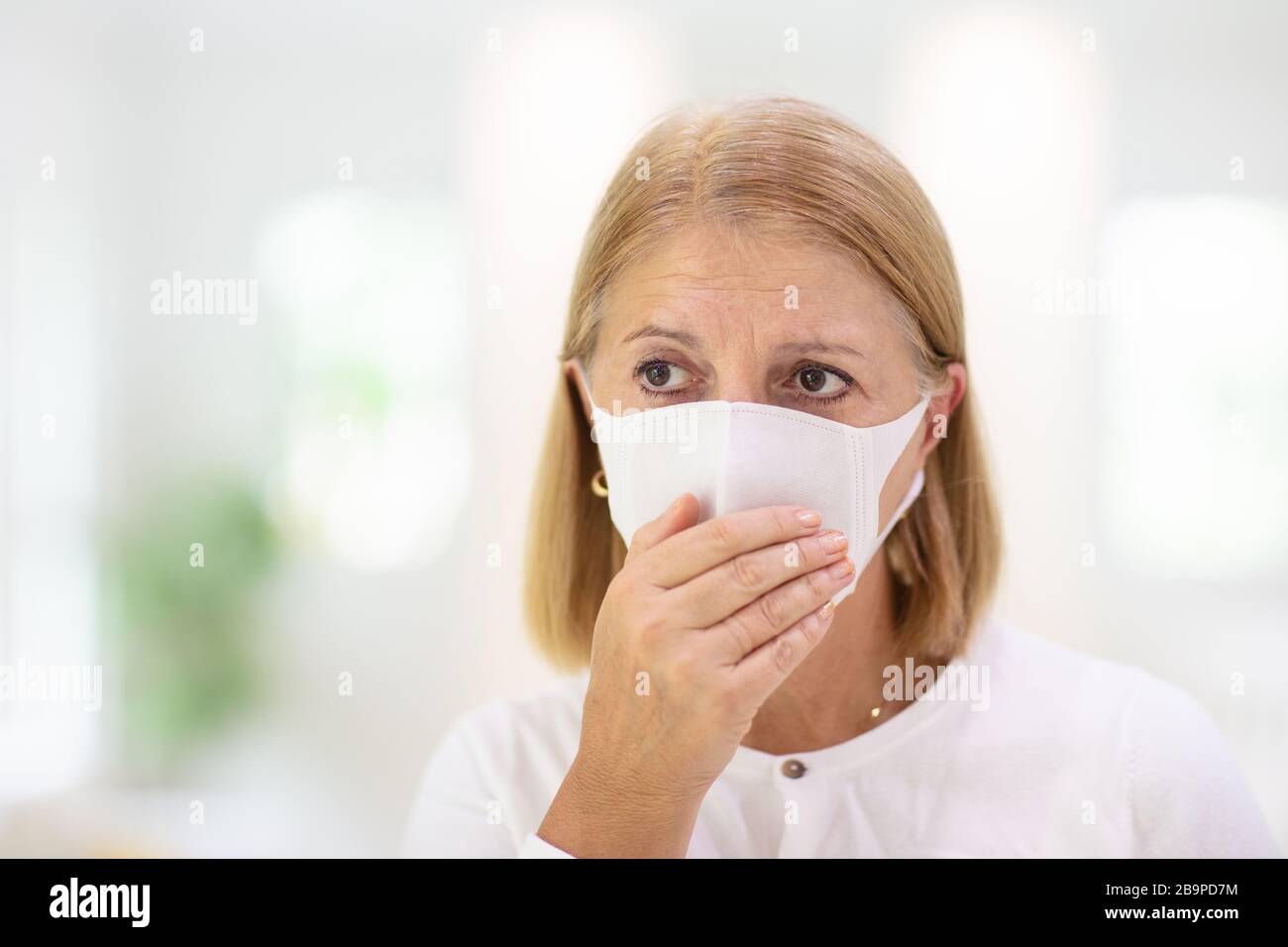 Senior woman wearing face mask during corona virus and flu outbreak ...