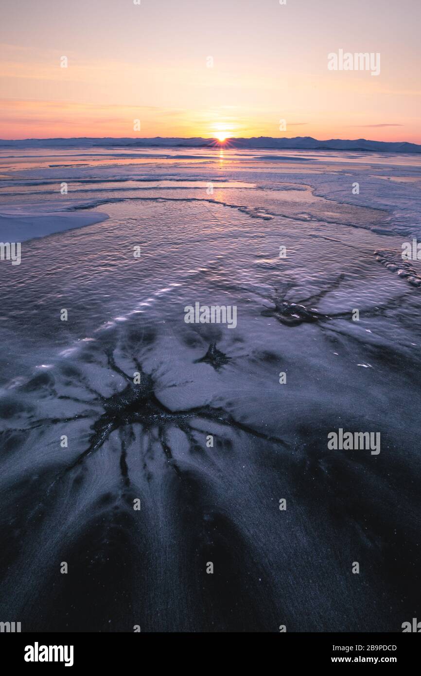 Frozen winter landscape of ice on lake Baikal during sunrise. Lake ...
