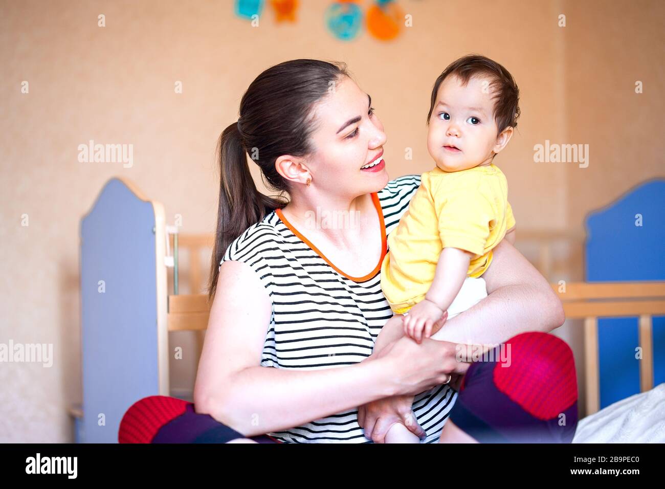 happy mother having fun with baby girl dark-haired mixed race kazakh ...