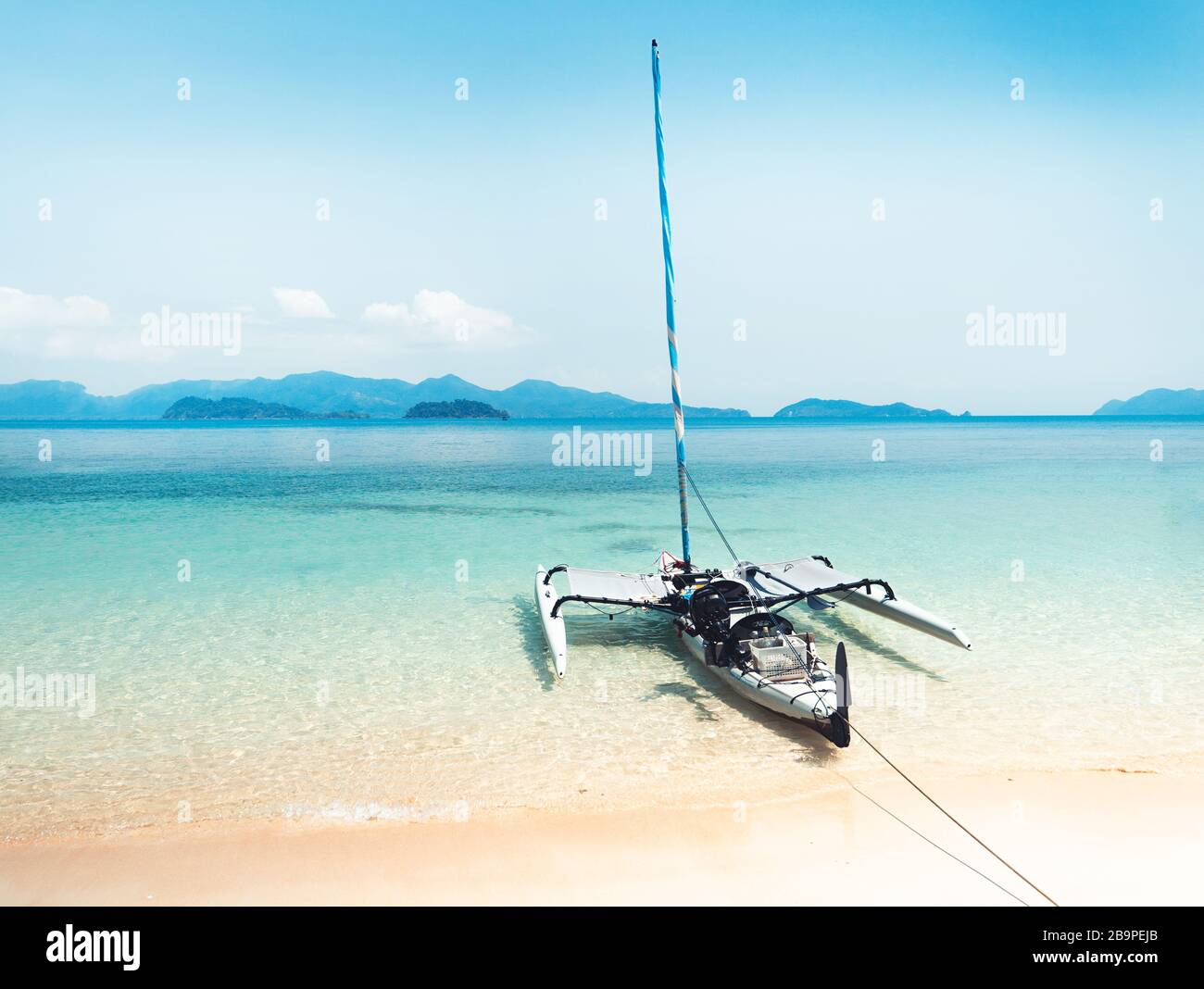Clear water on the island,Bright blue sea and wooden boat Stock Photo ...