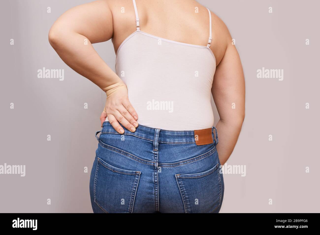 Woman lower back pain. Hold hand near body Stock Photo - Alamy