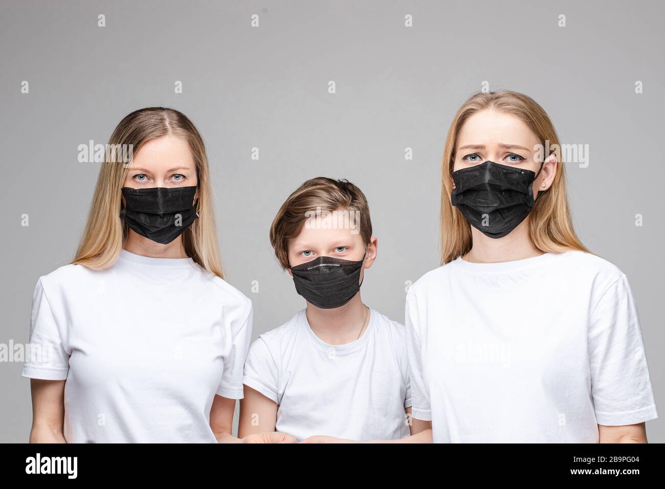 Three people in black anti-bacterial masks. Corona virus protection ...