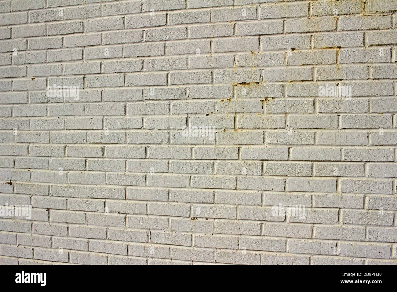 Grungy old white painted brick wall texture background with some rust ...
