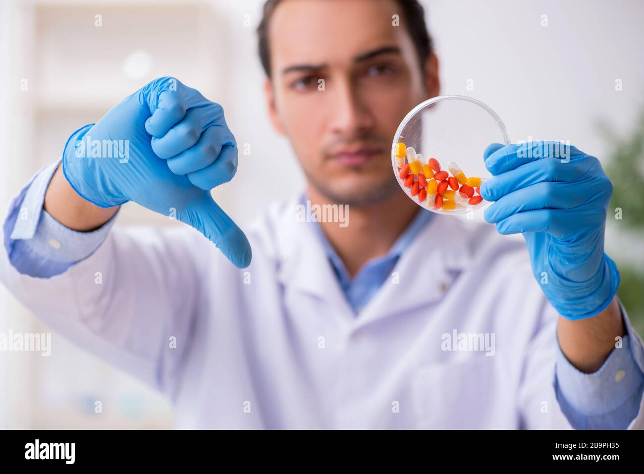 Young male lab assistant in the drug synthesis concept Stock Photo - Alamy