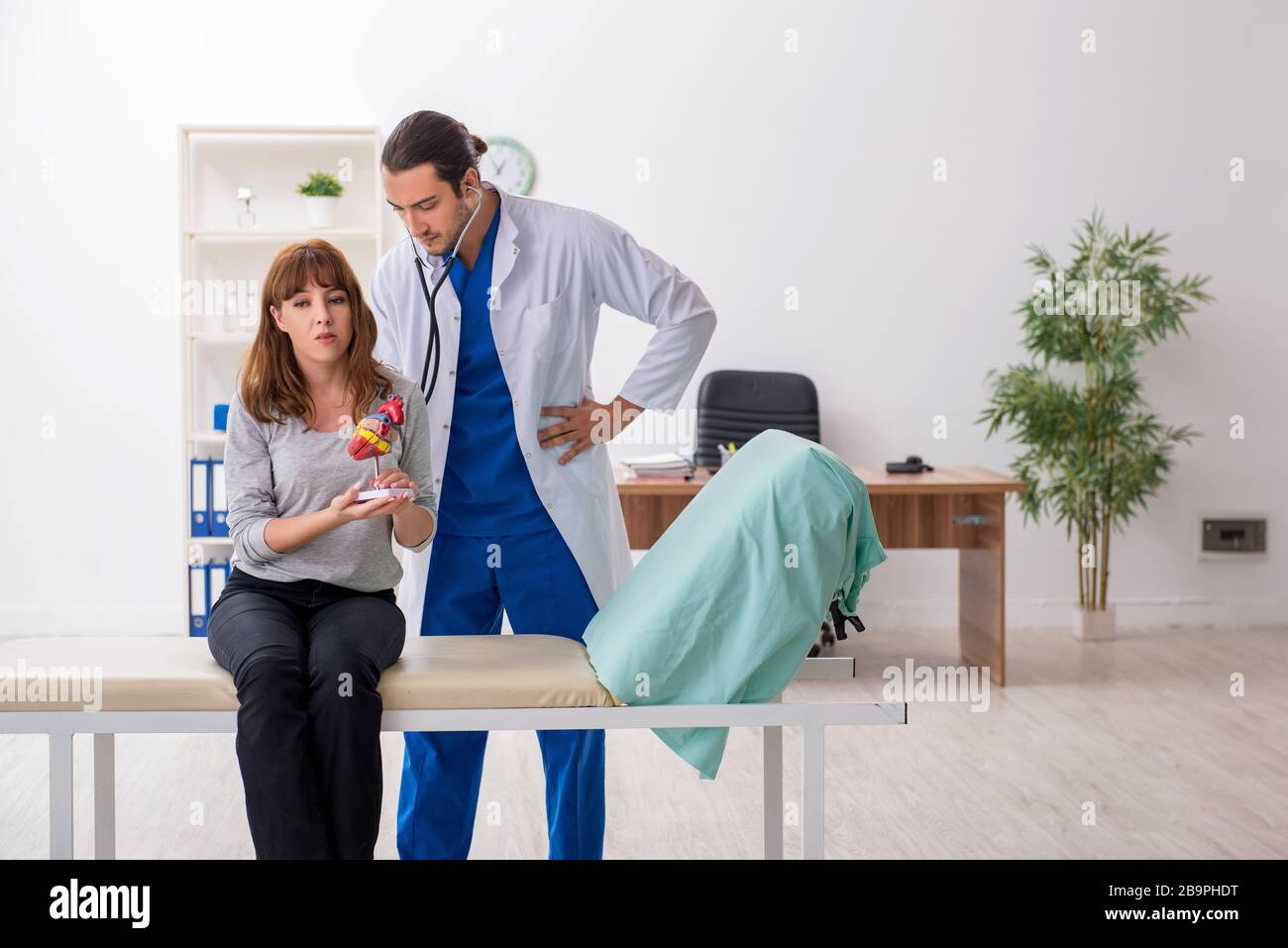 Young woman visiting doctor cardiologist Stock Photo - Alamy