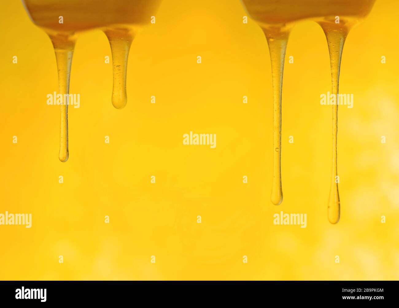 Honey flow dropping. Sweet amber flower honey flows Stock Photo - Alamy