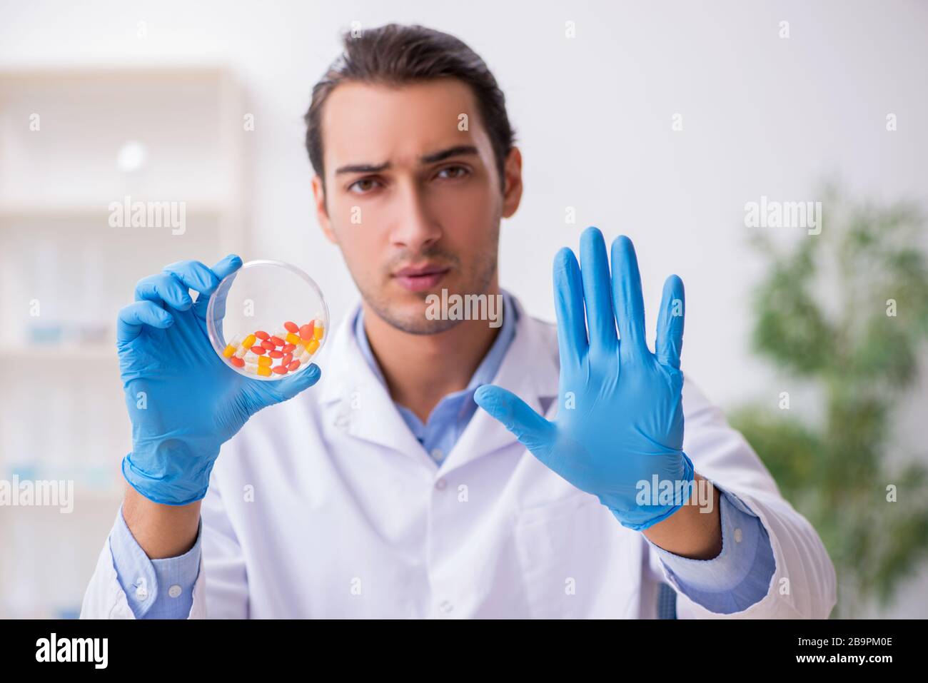 Young male lab assistant in the drug synthesis concept Stock Photo - Alamy