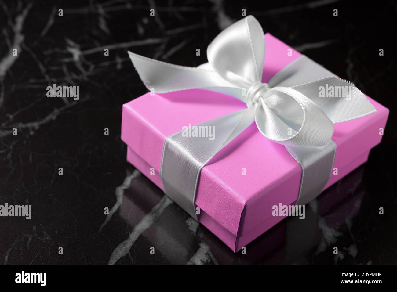 Luxury box tied on a marble table Stock Photo - Alamy