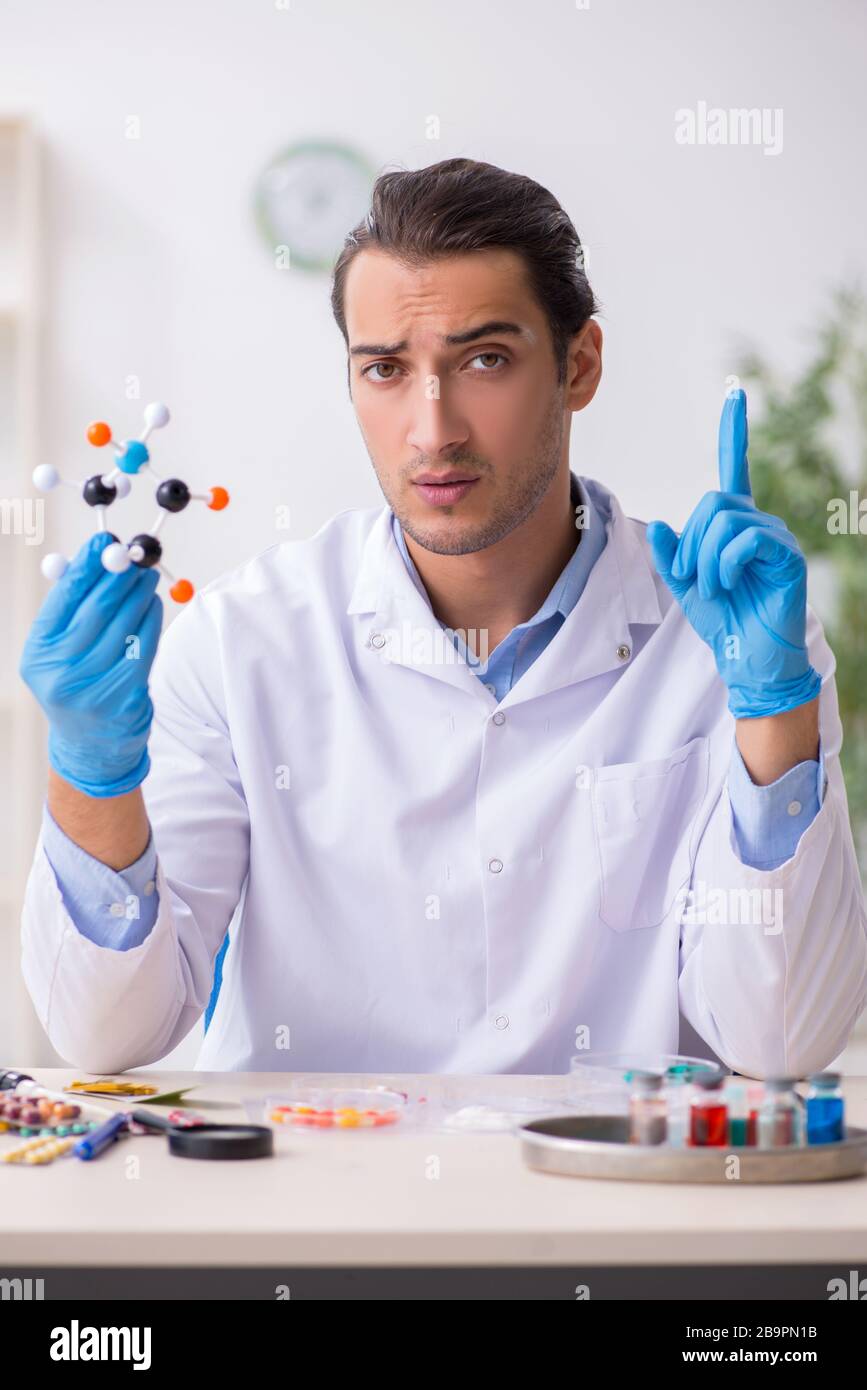 Young male lab assistant in the drug synthesis concept Stock Photo - Alamy