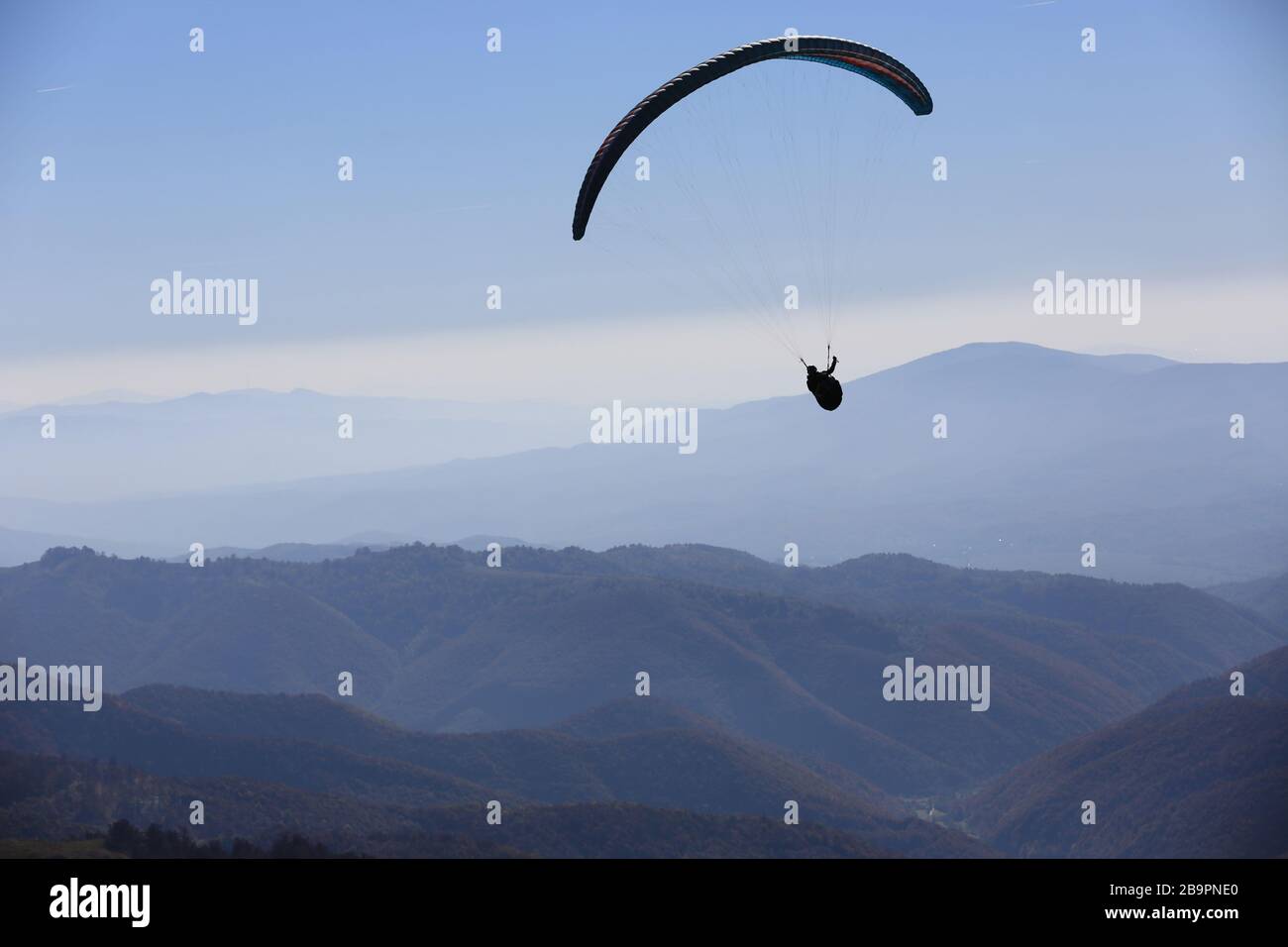 flying paraglider over mountains Stock Photo - Alamy