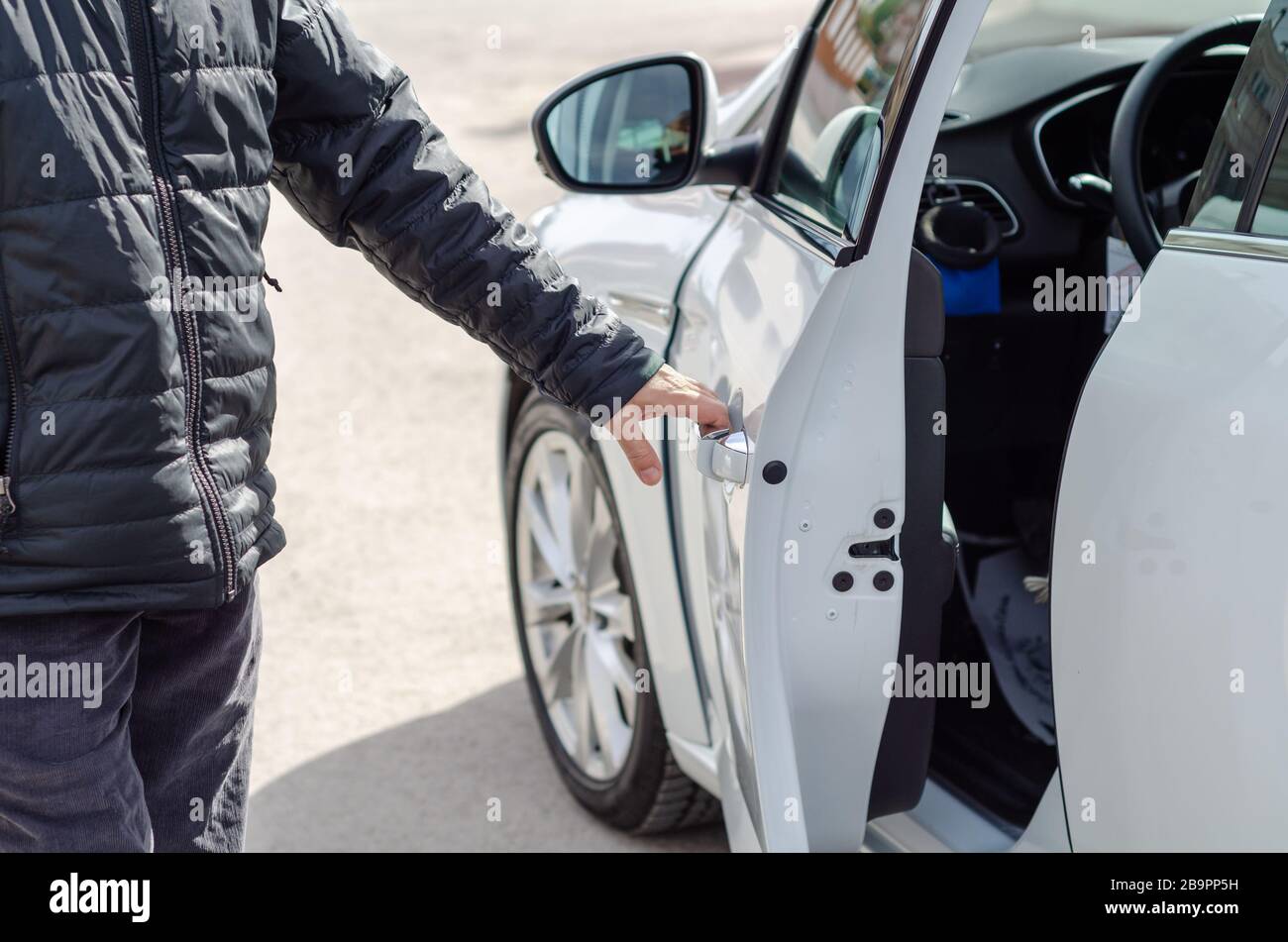The man is getting into a car Stock Photo - Alamy