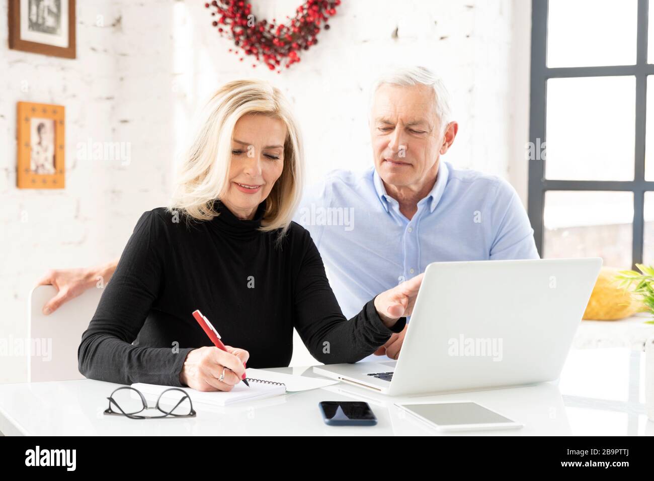 Mature couple doing family finances at home. Senior couple discussing ...