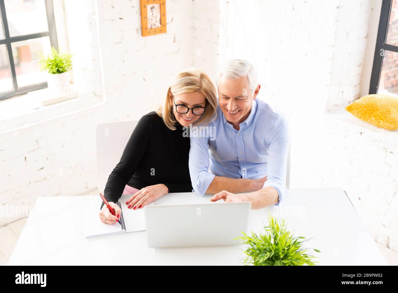 Mature couple doing family finances at home. Senior couple discussing ...