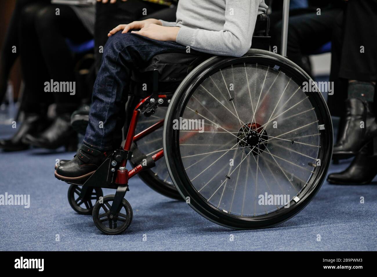 Details of an ill disabled young boy in a wheelchair Stock Photo - Alamy