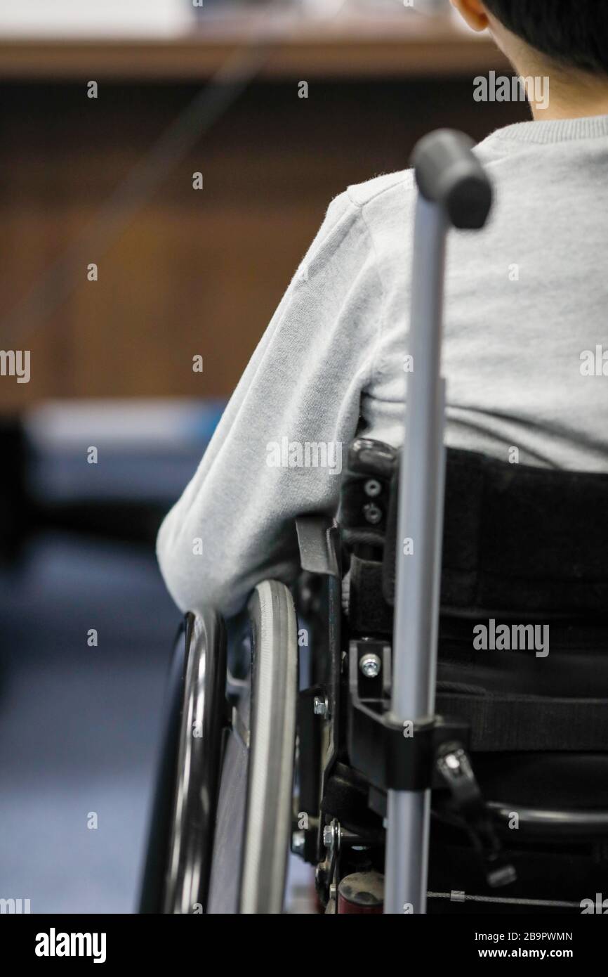Details of an ill disabled young boy in a wheelchair Stock Photo - Alamy