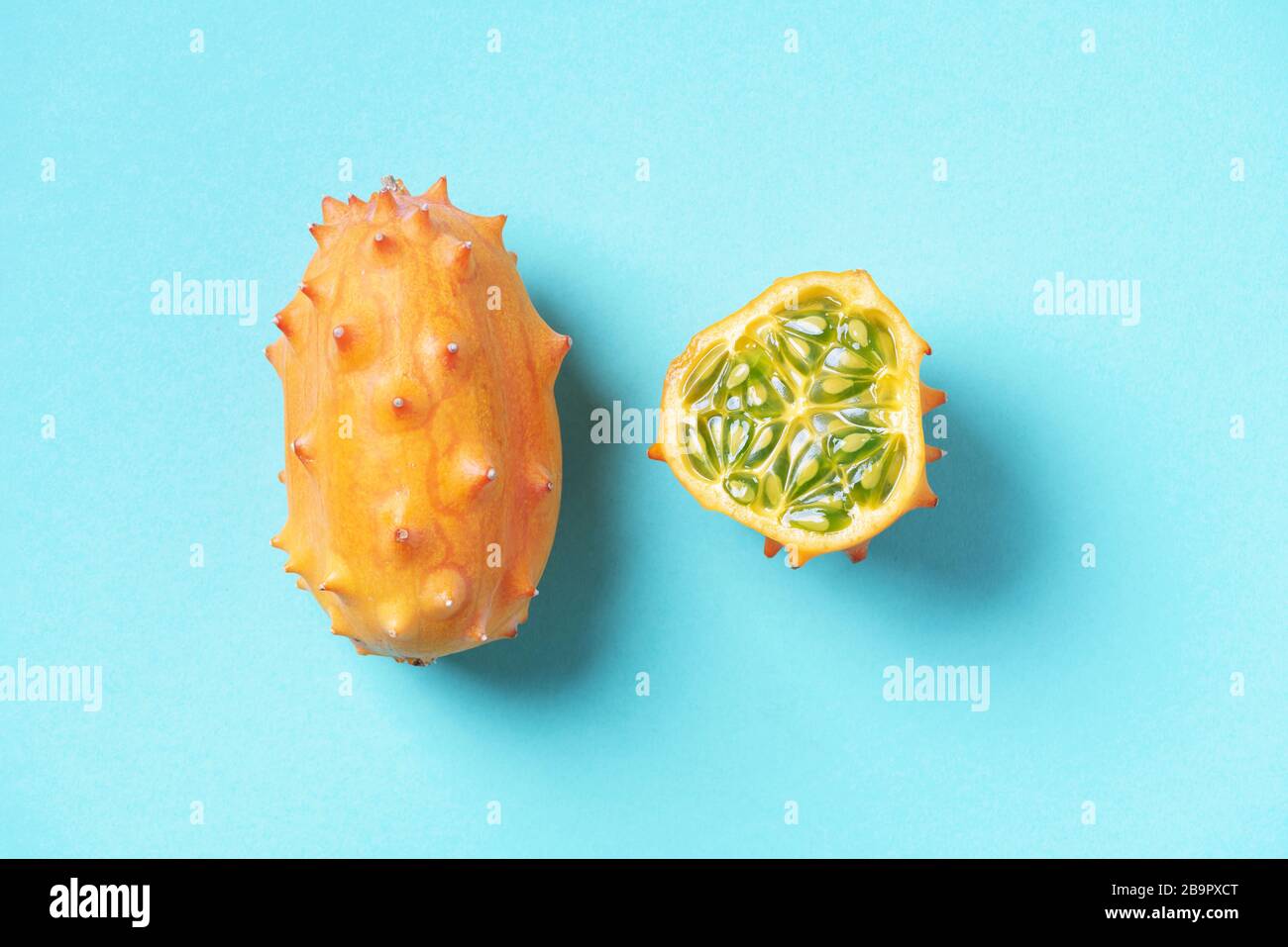 Kiwano or african horned melon on blue background. Top view. Cutted ...