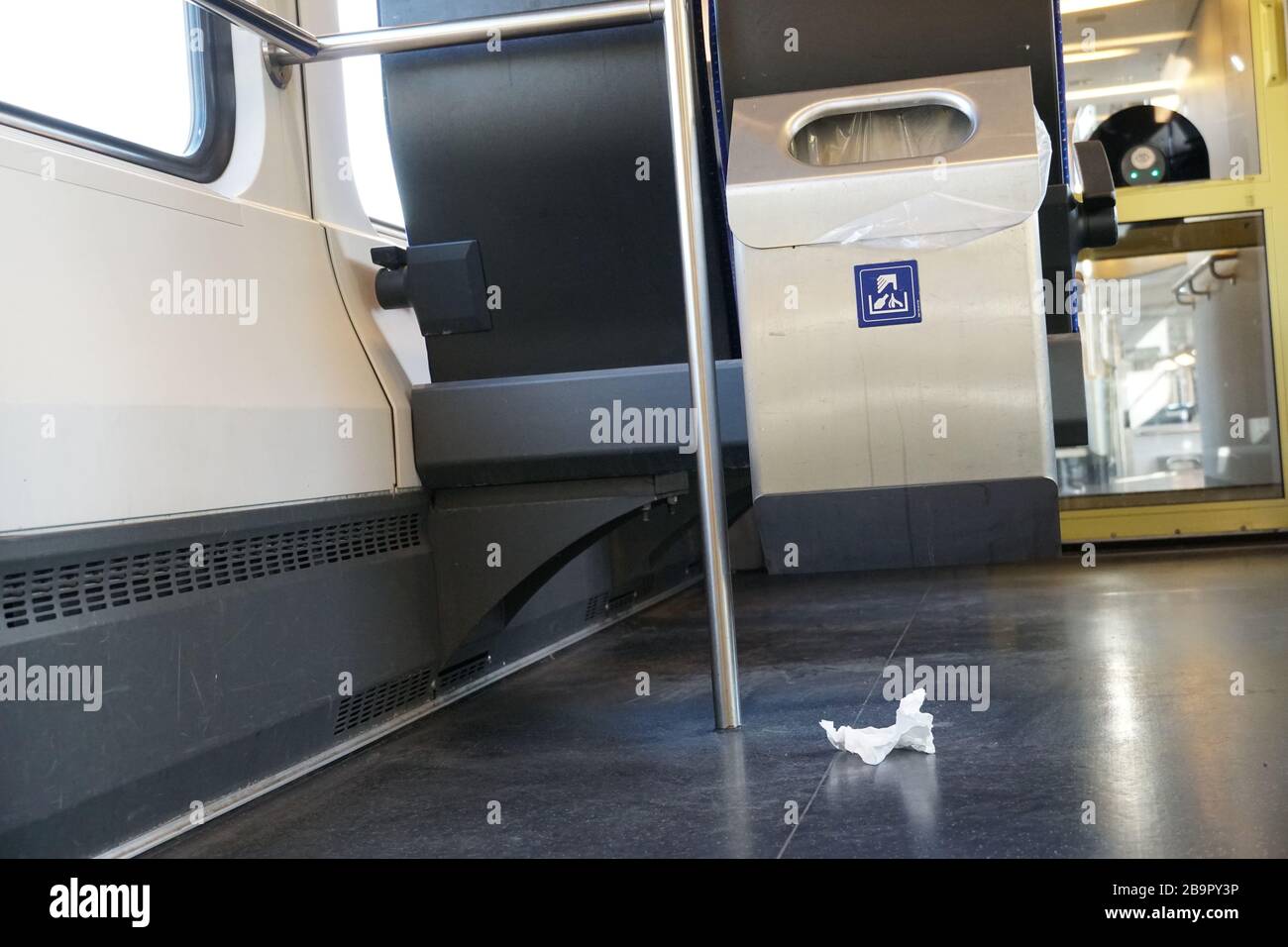 a used paper tissue out of waste bin or dust bin in a commuter train ...