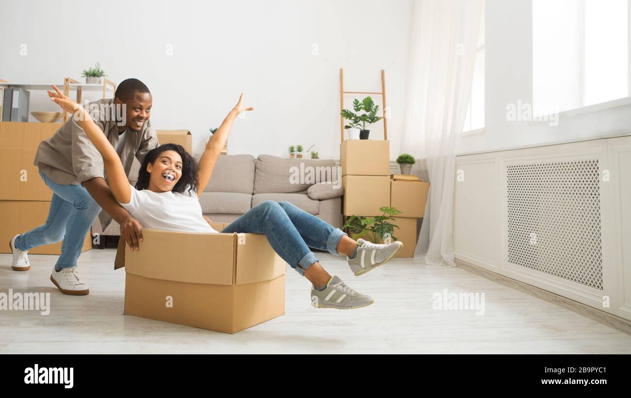 Female in box and guy pushing her by the room Stock Photo - Alamy
