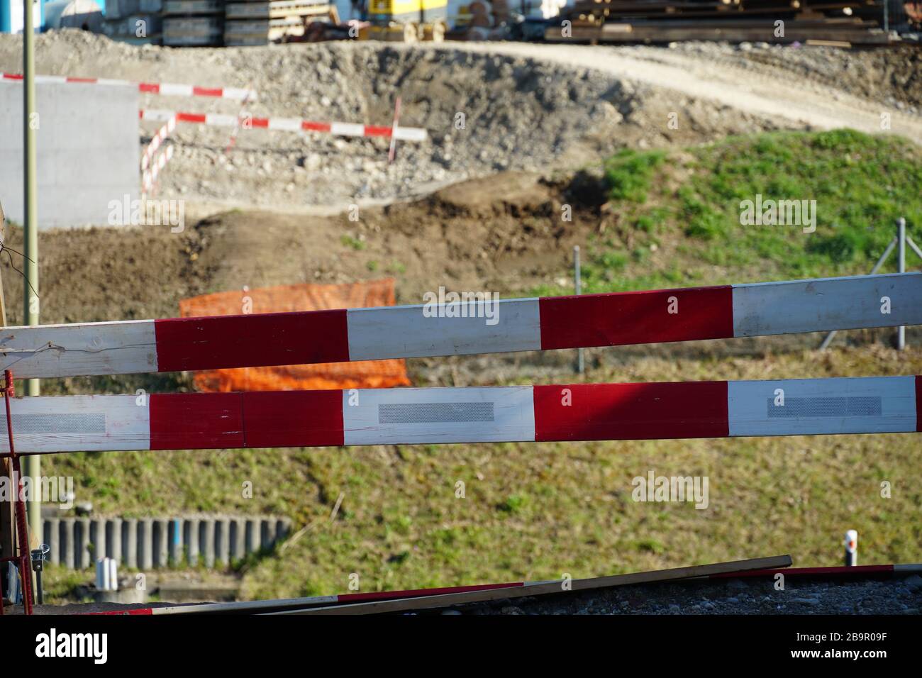 Barrier planks in red and white on a building or construction site of ...