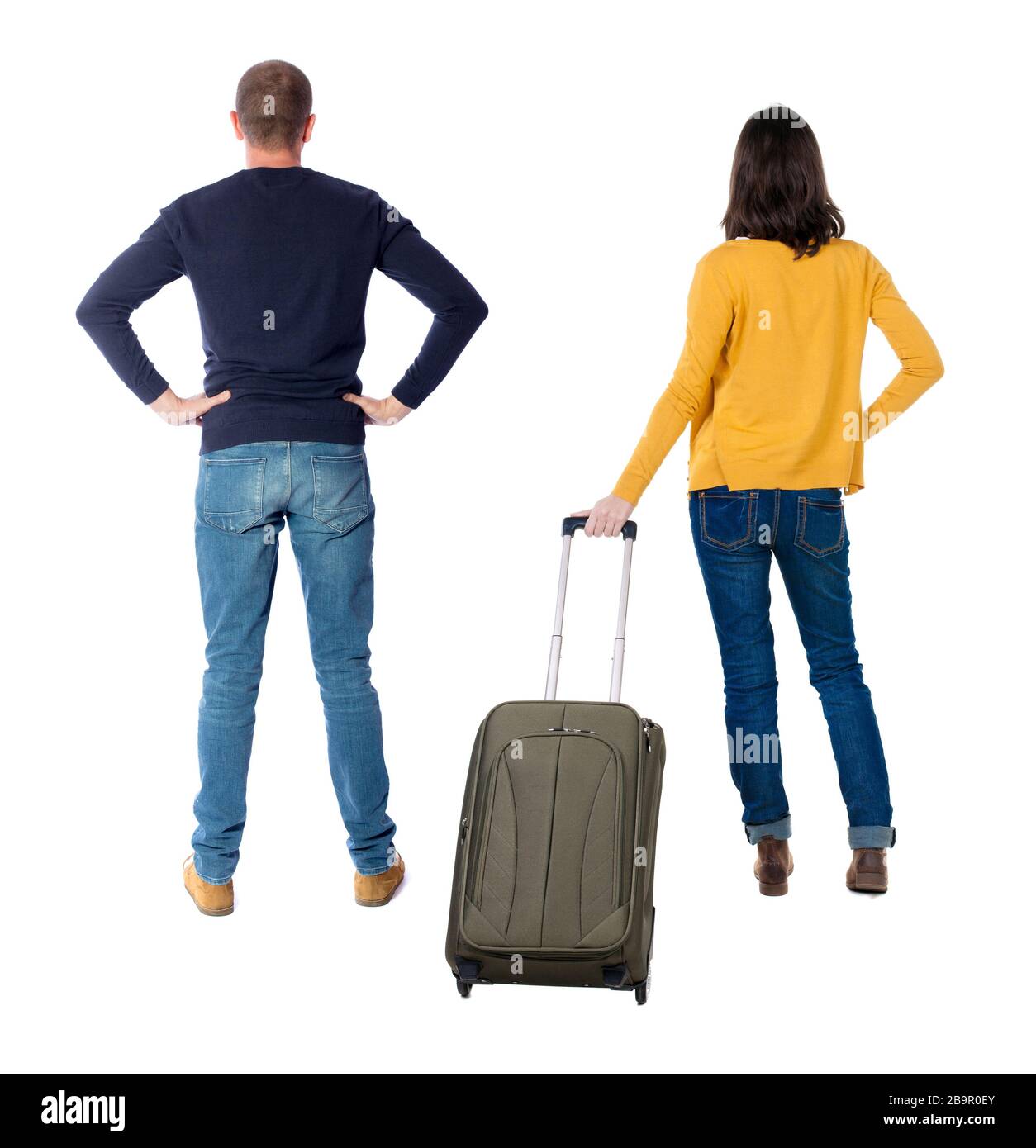 young couple in sweater traveling with suitcas. Back view. Rear view ...