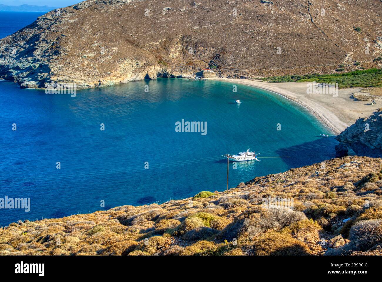 The beach of Achla and Saint Nikolaos church on the island of Andros ...