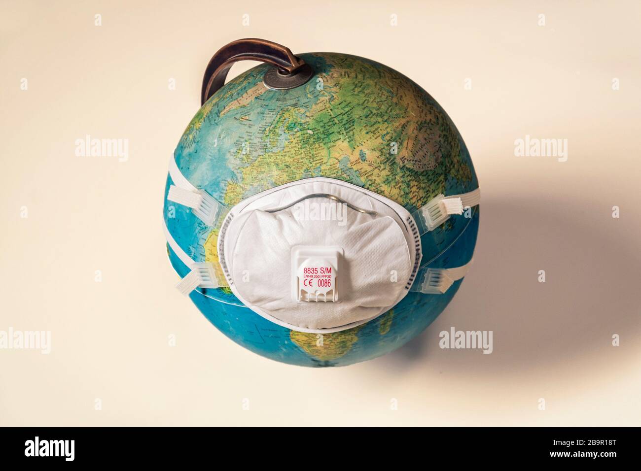 Earth globe wearing surgical face mask, respirator for protection ...