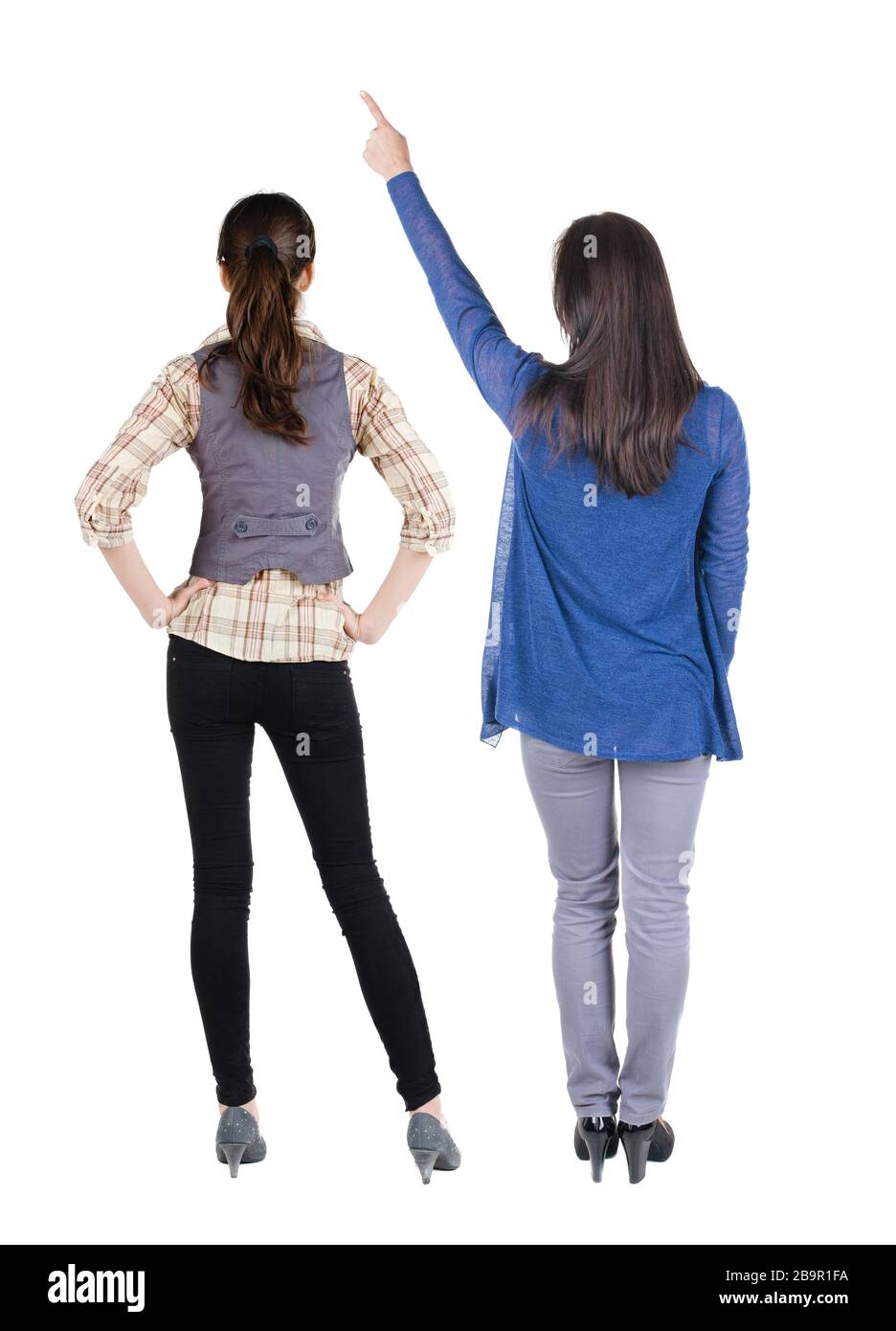 Back view of two pointing girl in sweater. Rear view people collection ...